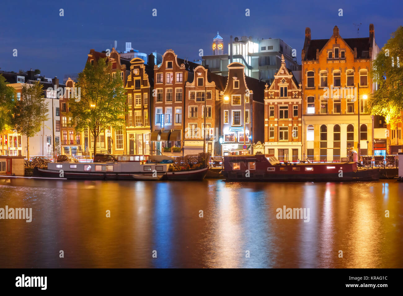 Night city view of Amsterdam canal with dutch houses Stock Photo - Alamy