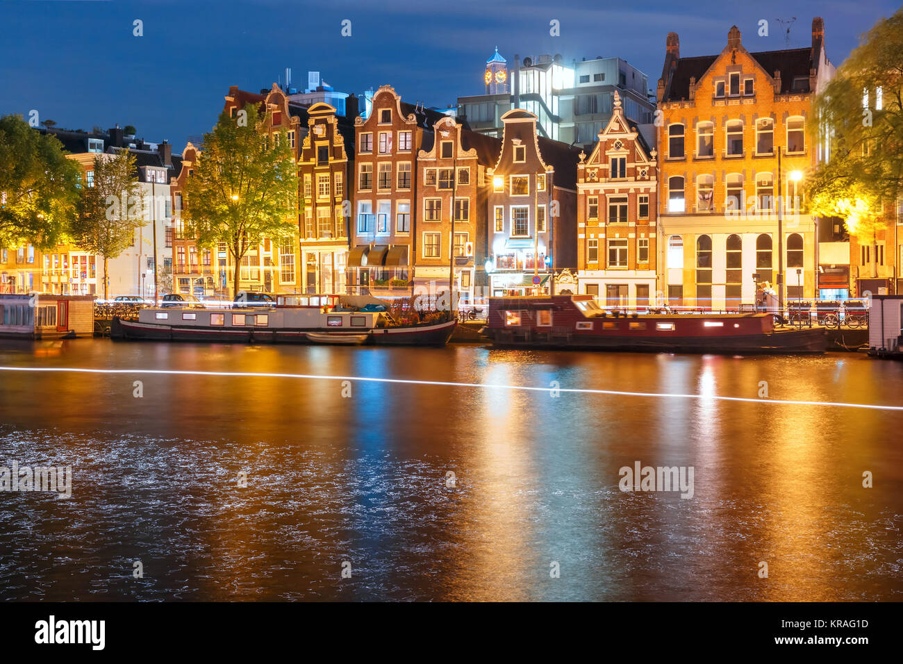 Night city view of Amsterdam canal with dutch houses Stock Photo - Alamy
