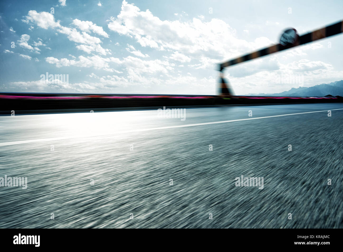 blurry empty asphalt road with road sign in blue cloud sky Stock Photo ...