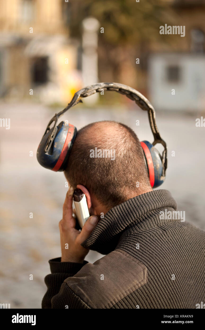 Calling with mobile and headphones Stock Photo - Alamy
