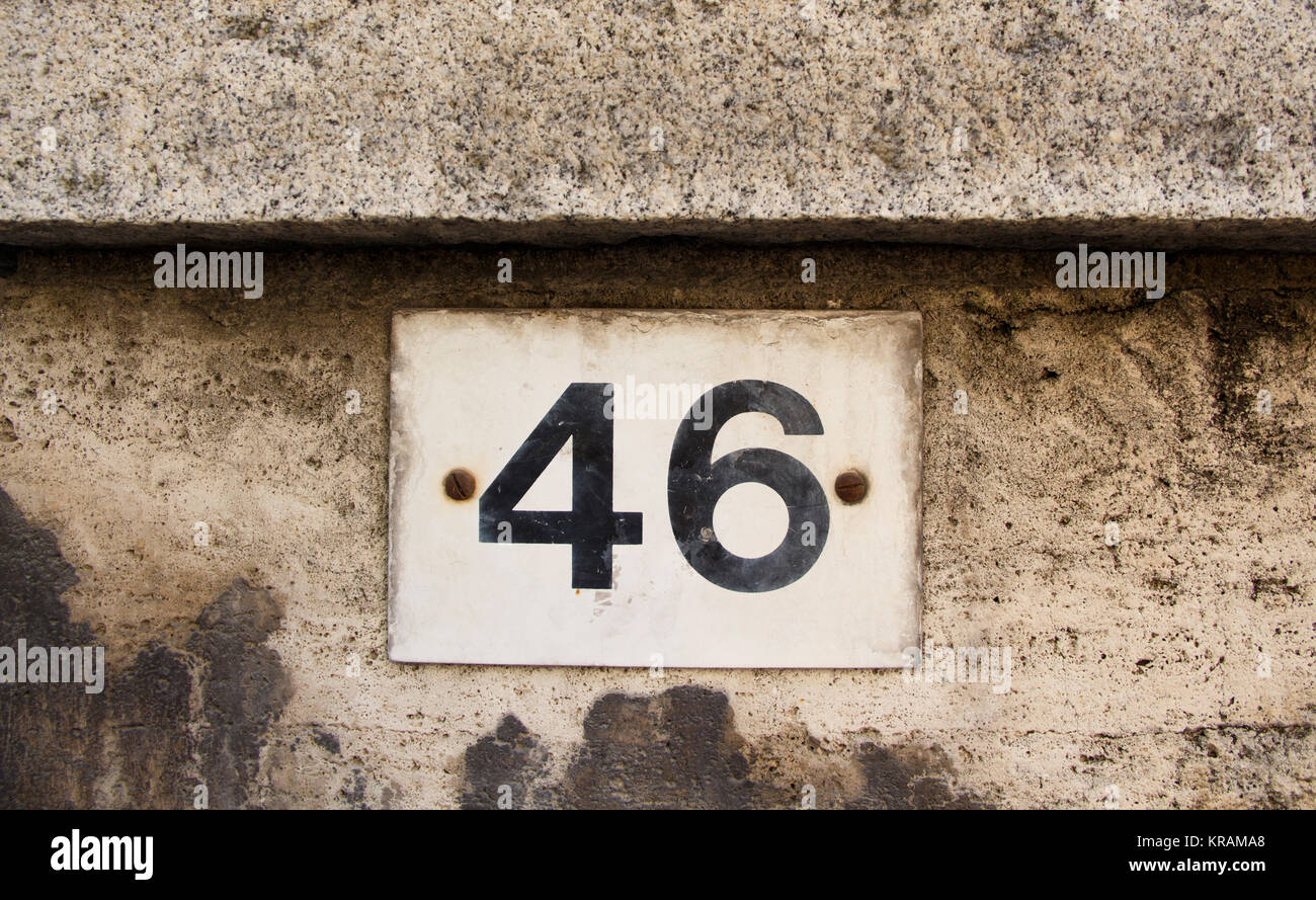 Number forty six on the grey stone wall Stock Photo - Alamy