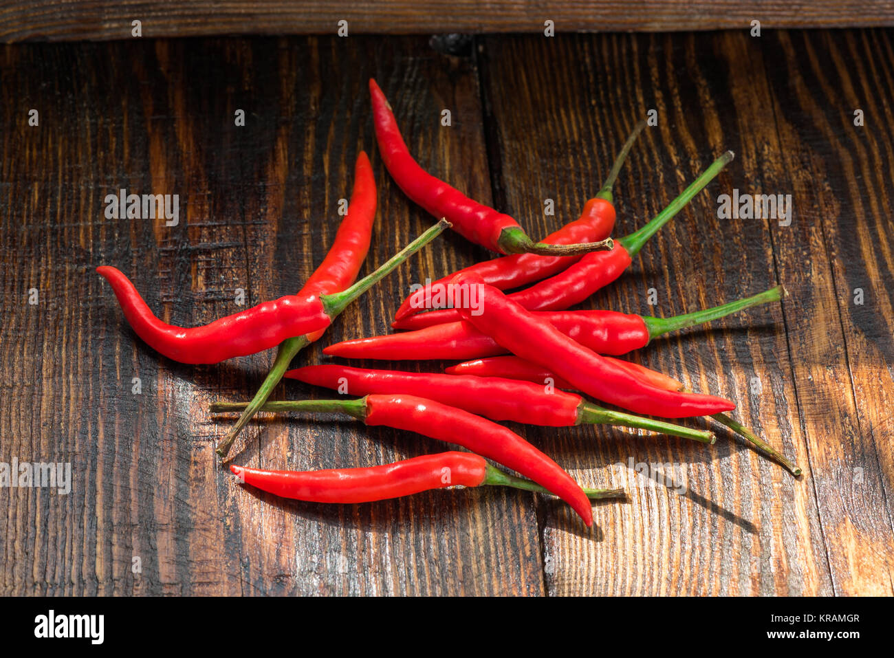 Pile of thai Bird's Eye Chilis on a old wooden table Stock Photo - Alamy
