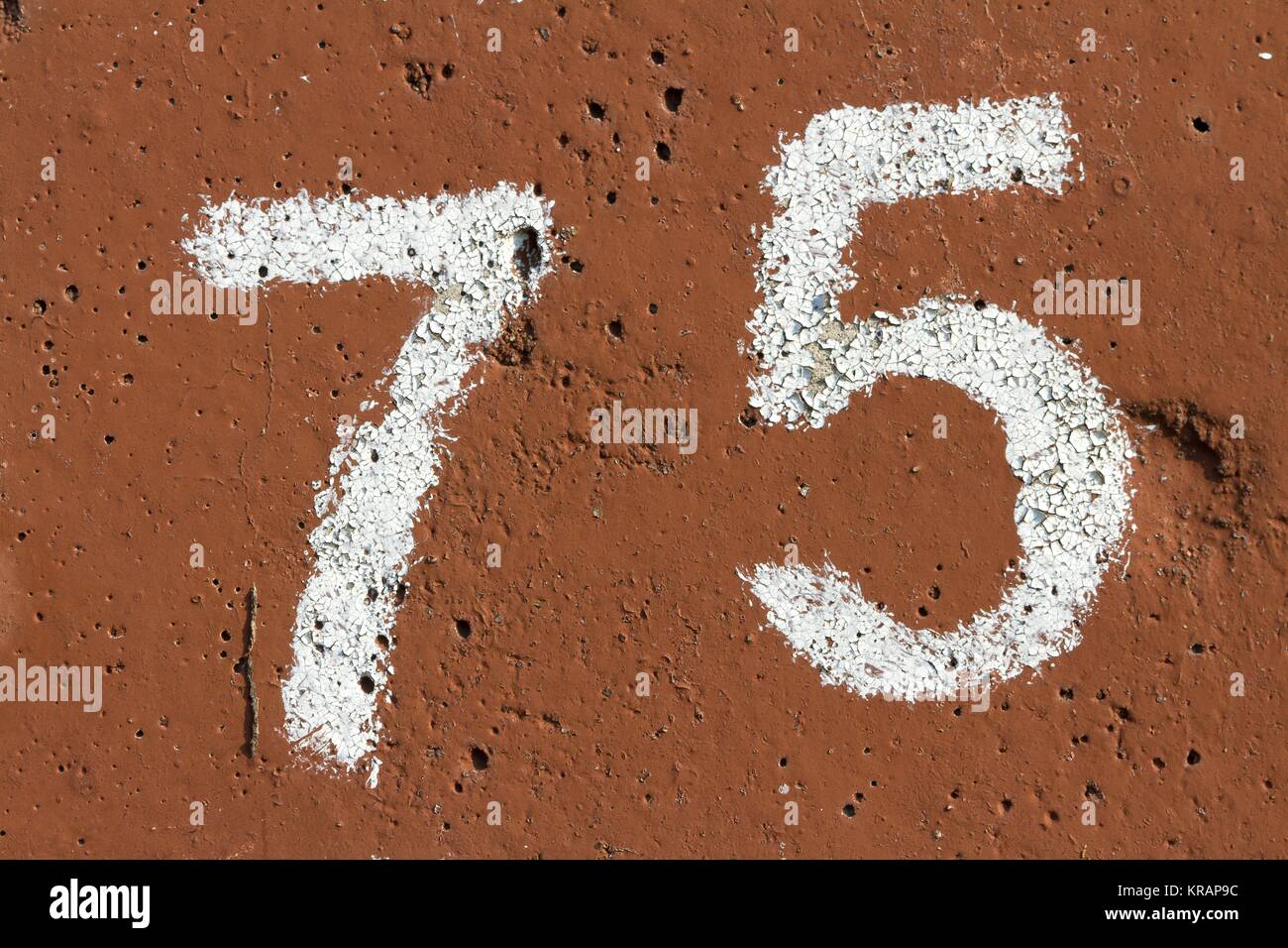 seventy-five on maroon background Stock Photo - Alamy