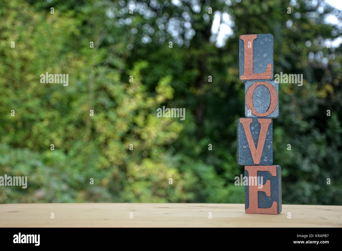 blocks with love lettering stacked high against natural background ...