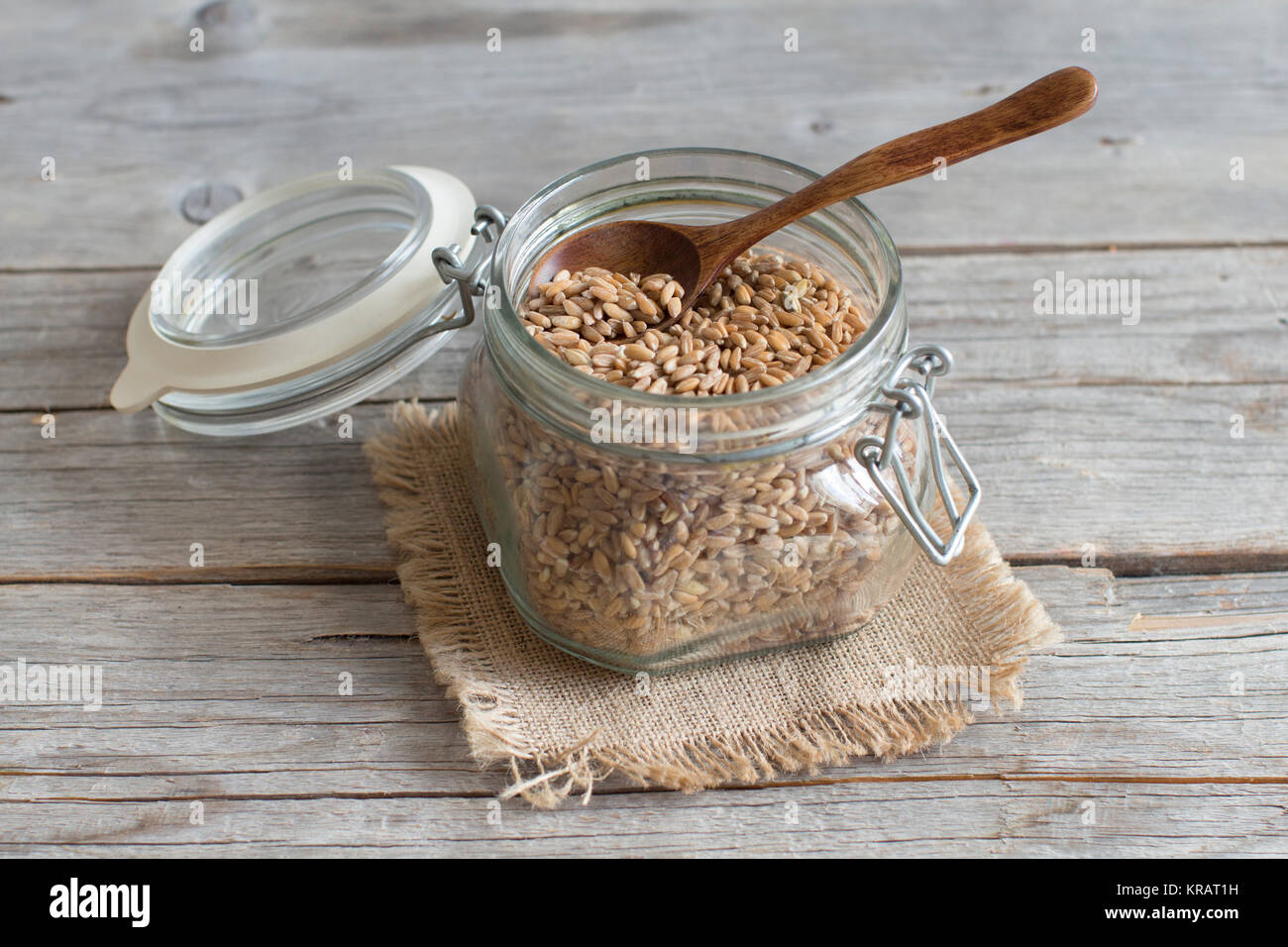 Raw whole spelt in a glass jar Stock Photo - Alamy