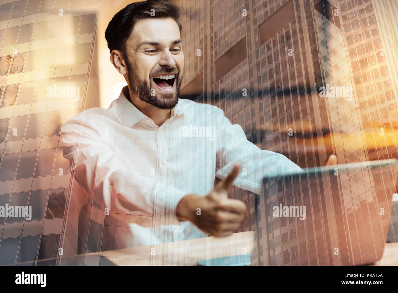 Happy man showing thumbs up while having video call Stock Photo - Alamy