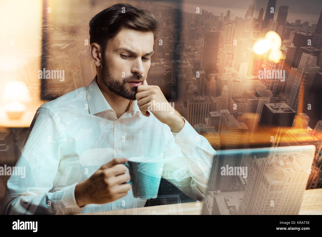 Handsome man drinking coffee and thinking about work Stock Photo - Alamy