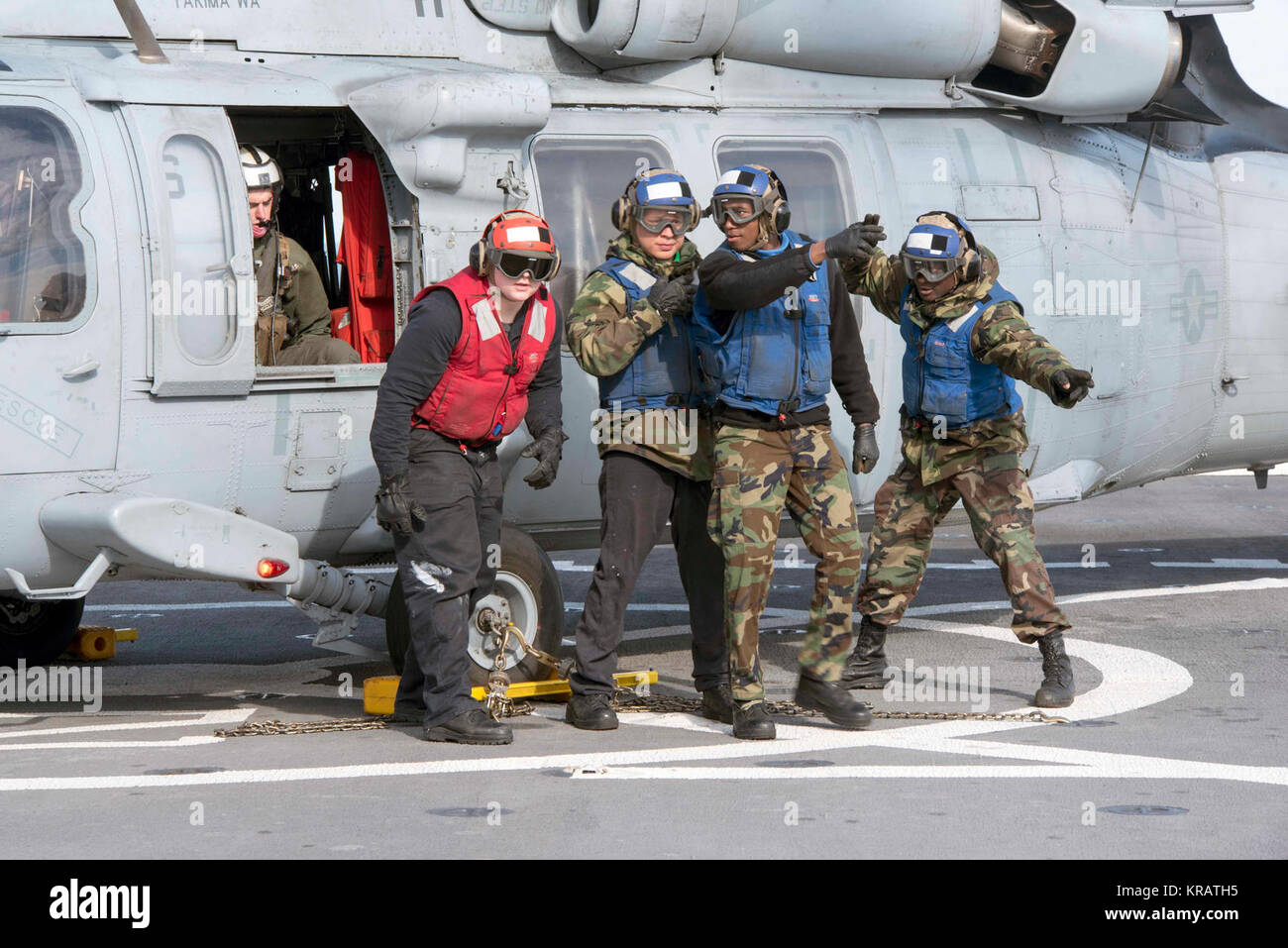 US navy MH-60S helicopter on deck with crewmen Stock Photo - Alamy