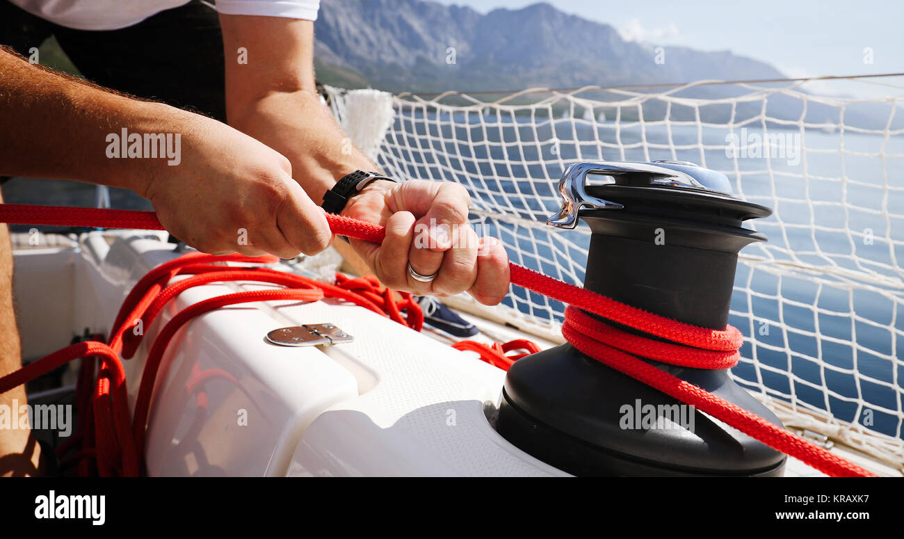 Young strong woman sailing the boat Stock Photo - Alamy