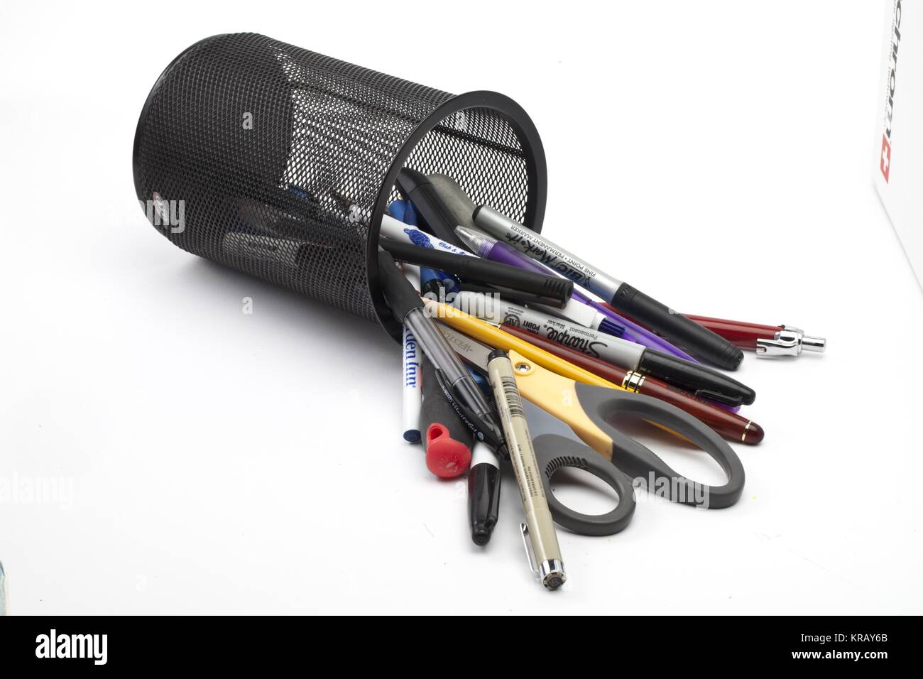 close up shot of pens and scissors spilled over white background Stock ...