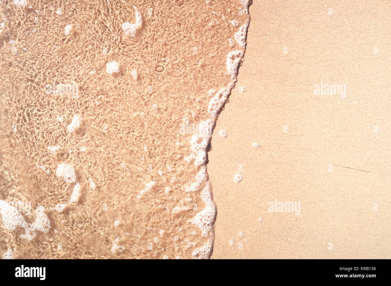 Transparent soft wave on sandy beach Stock Photo - Alamy