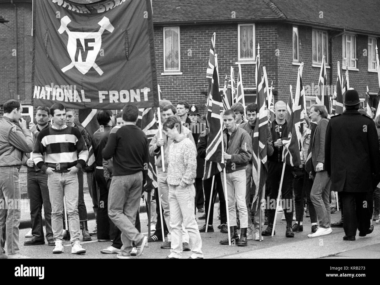 National Front supporters display a Union Flag while police monitor the ...