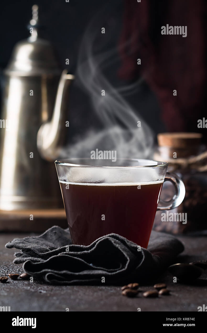 Hot Coffee espresso with smoke in transparent glass cup on black ...
