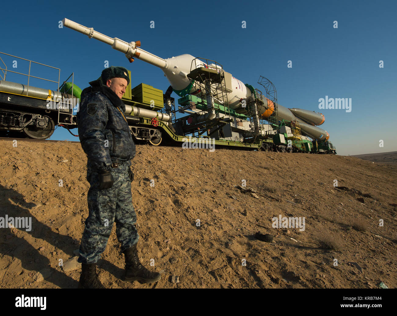 A Russian security guard is seen as the Soyuz rocket is rolled out to ...