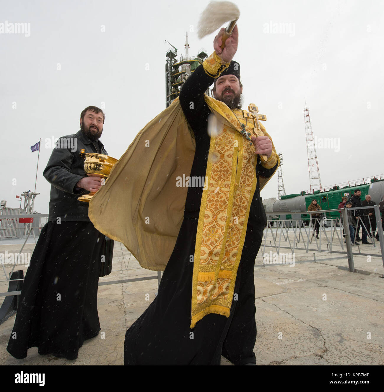 An Orthodox priest blesses members of the media shortly after blessing ...