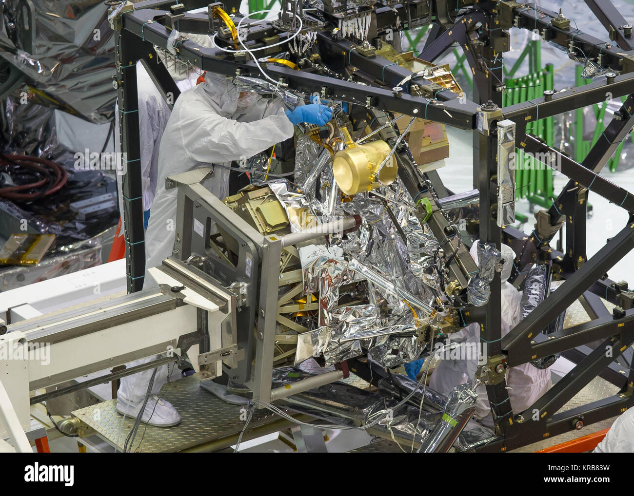 A technician is installing the bolts that will hold the MIRI, or Mid ...