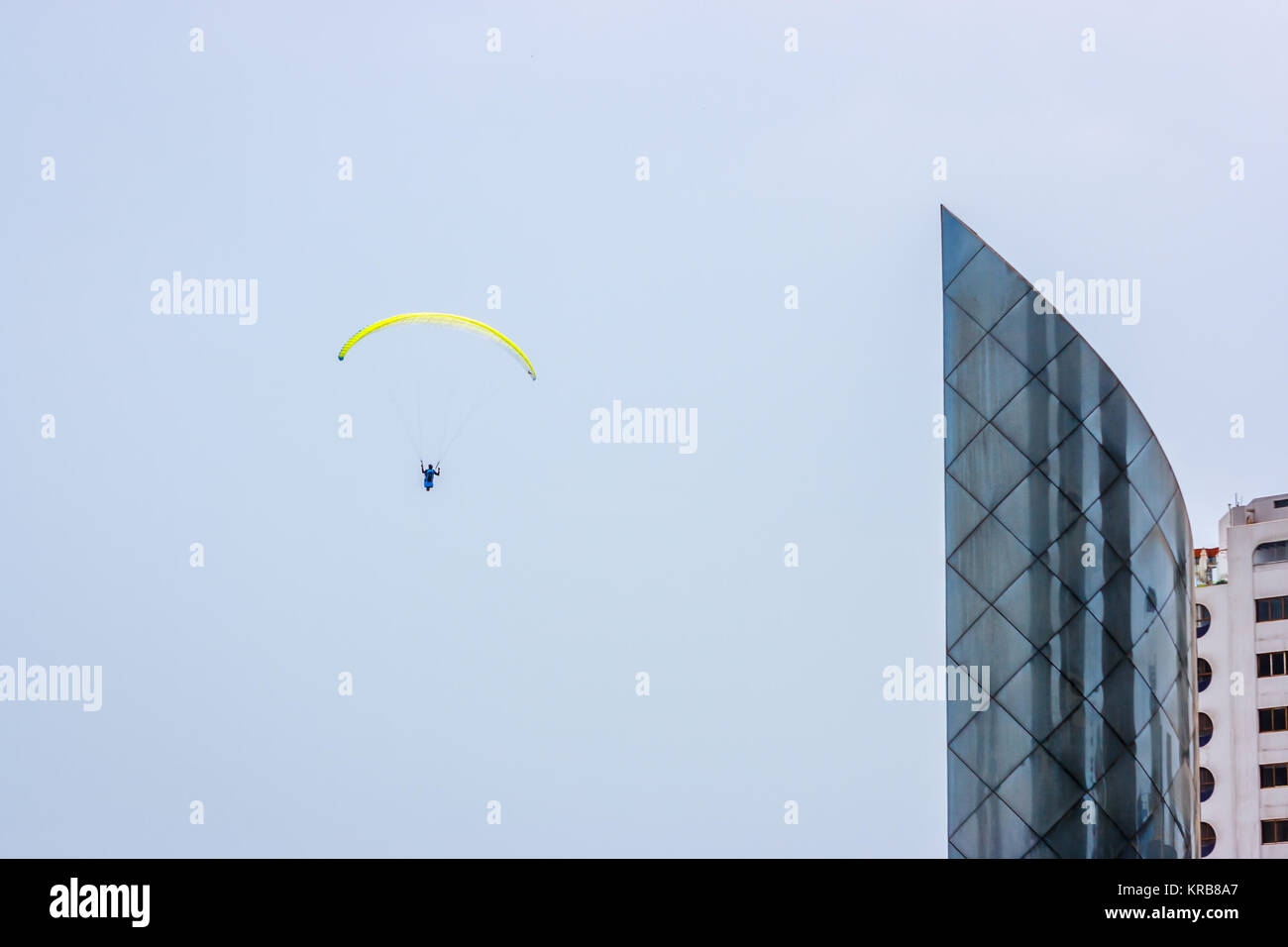 Yellow paraglider flying over Lima, Peru Stock Photo - Alamy