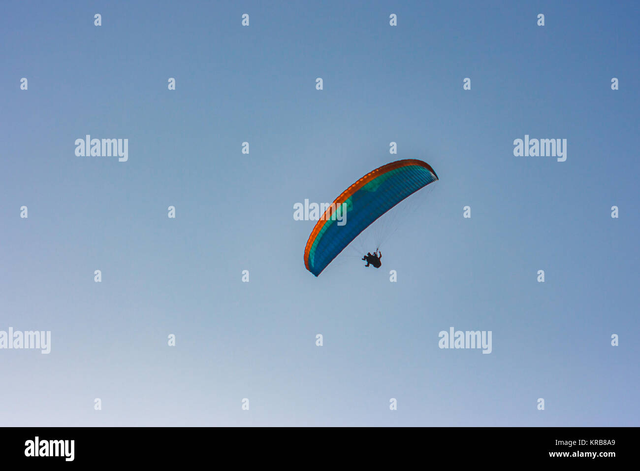 Blue and orange paraglider flying over Lima, Peru Stock Photo - Alamy
