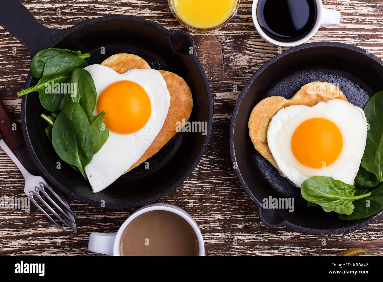 Valentine's day breakfast or brunch. Homemade heart shape fried egg and pancake in cast iron ...