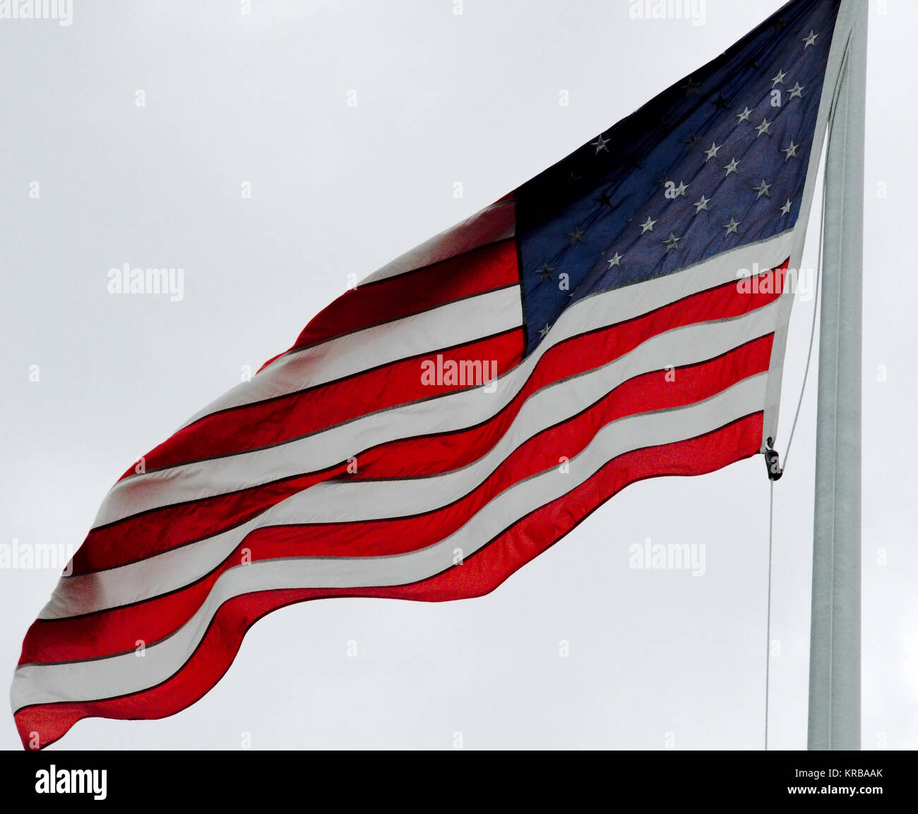 A waving American Flag on a pole Stock Photo - Alamy