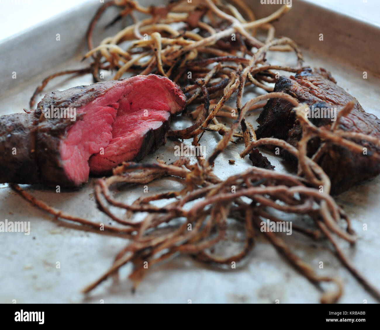 Beef loin with string on a baking tray Stock Photo - Alamy
