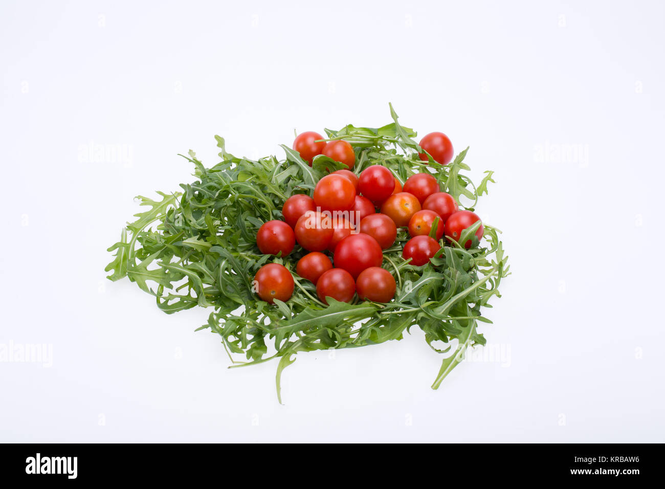 Heap of ruccola leaves and cherry tomatoes Stock Photo - Alamy