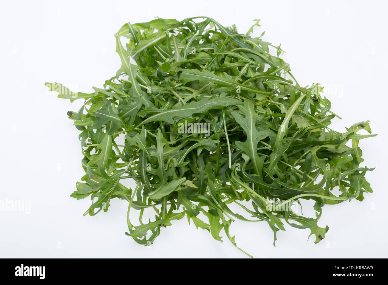Heap of ruccola leaves isolated on white background Stock Photo - Alamy