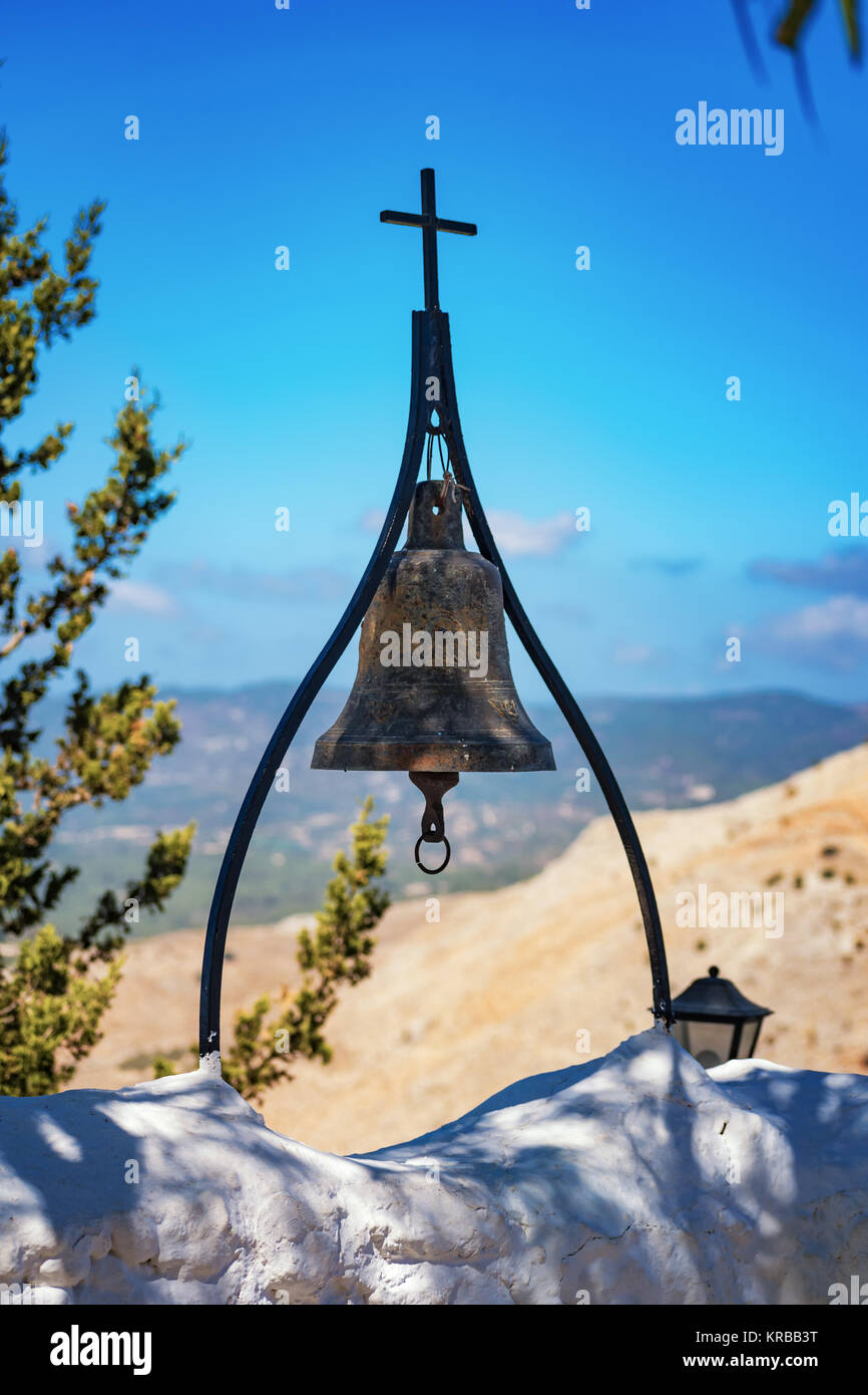 Bronze bell with cross on wall of Tsambika Monastery, (RHODES, GREECE ...