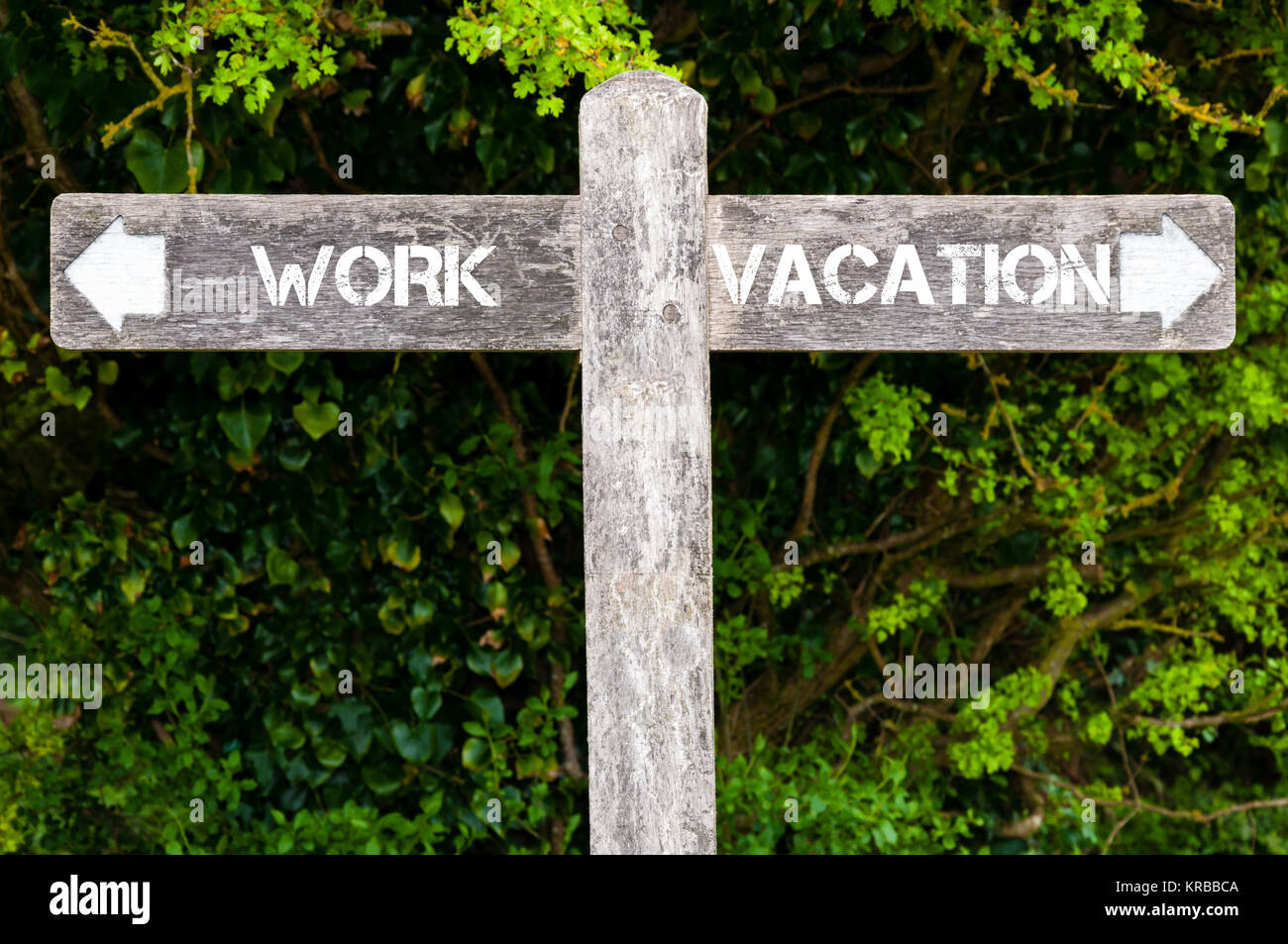 WORK versus VACATION directional signs Stock Photo - Alamy