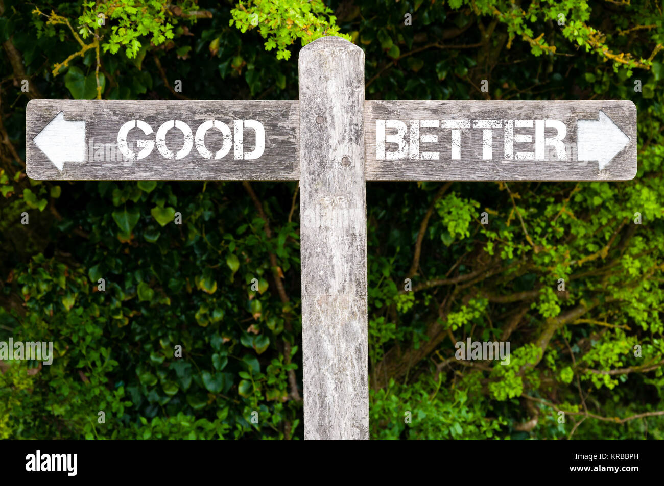 GOOD versus BETTER directional signs Stock Photo - Alamy