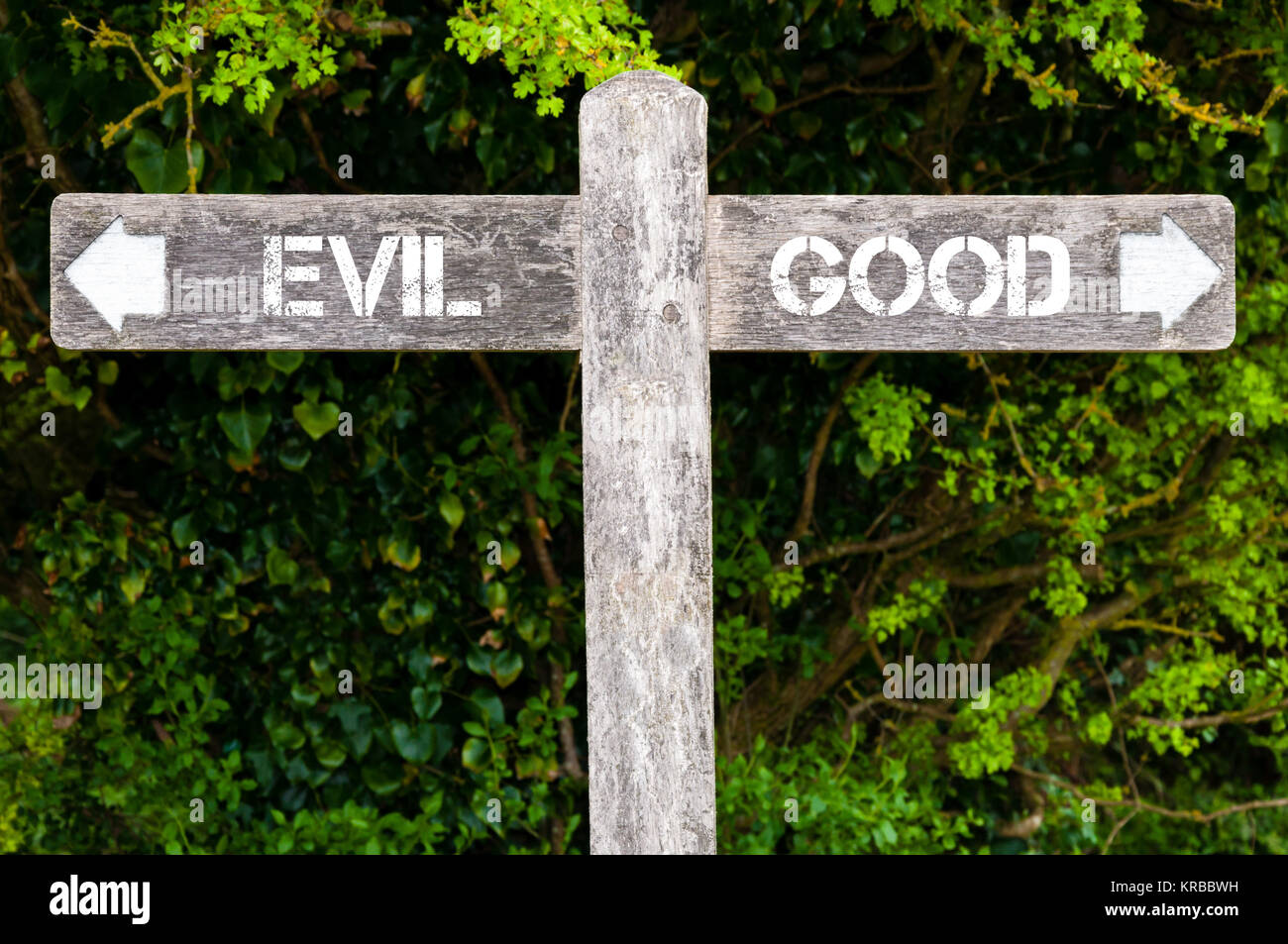 Evil versus Good directional signs Stock Photo - Alamy