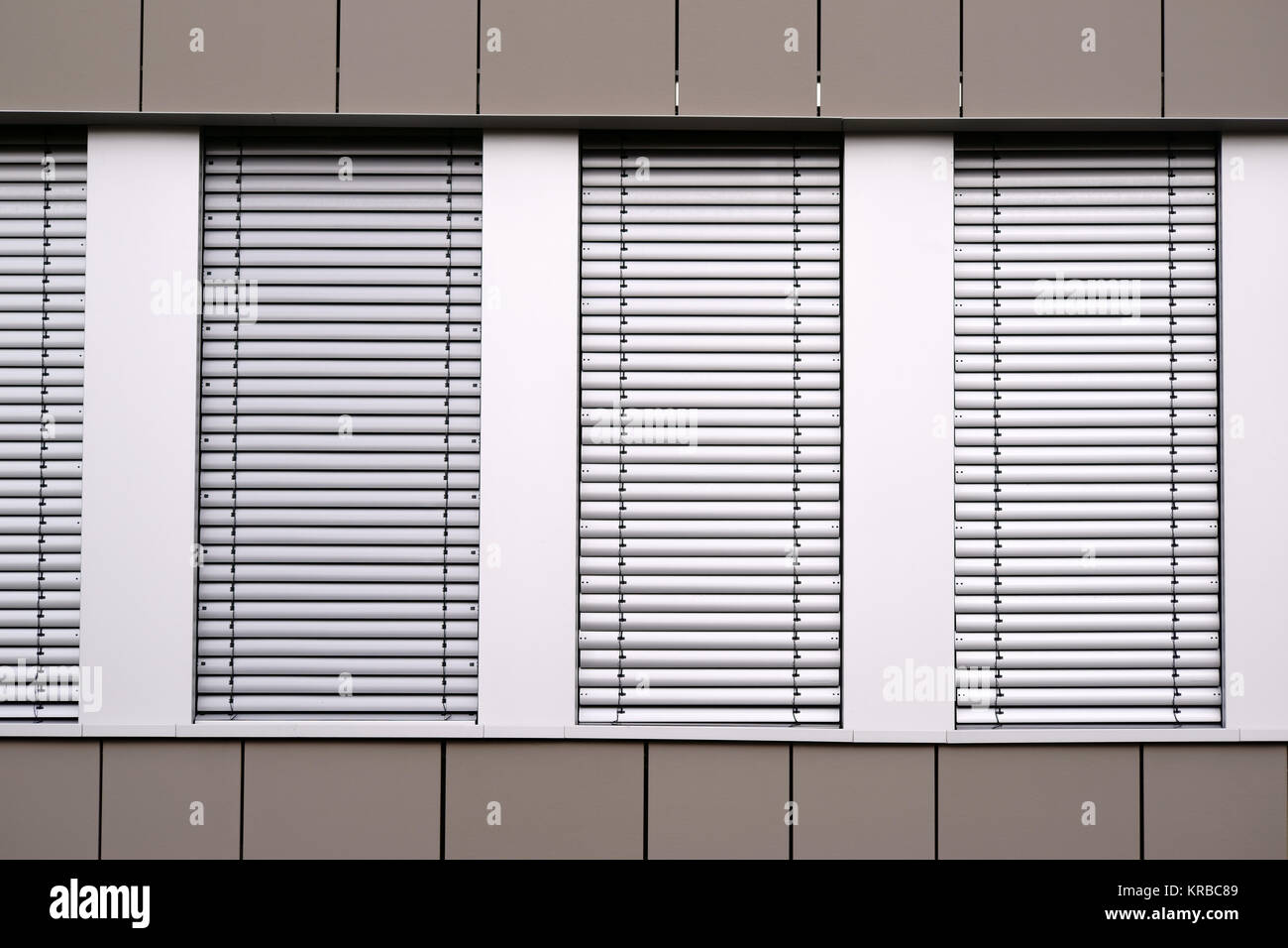 The modern facade of an office building with window rows and metal ...