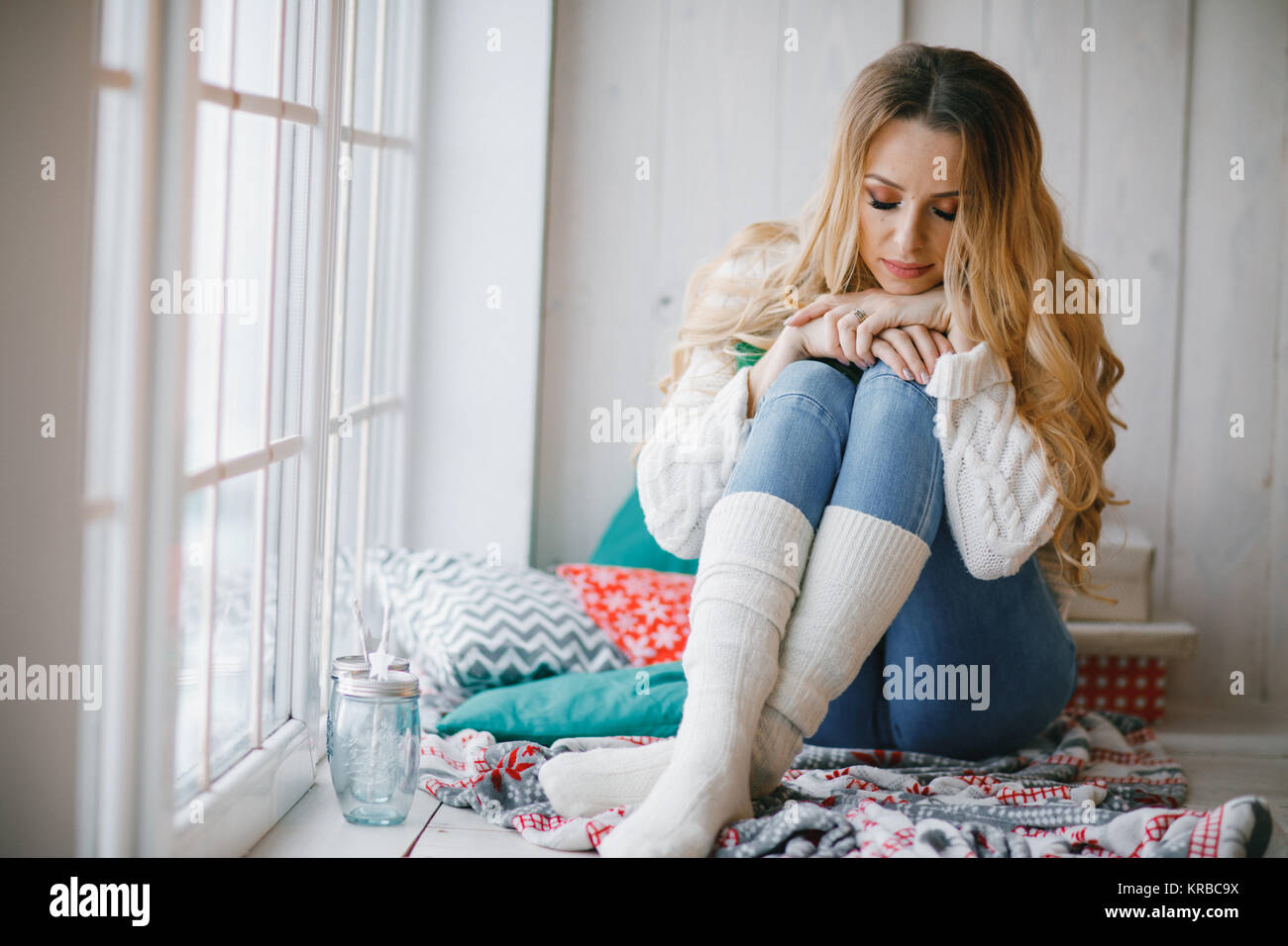 beautiful woman sitting on the window still Stock Photo - Alamy