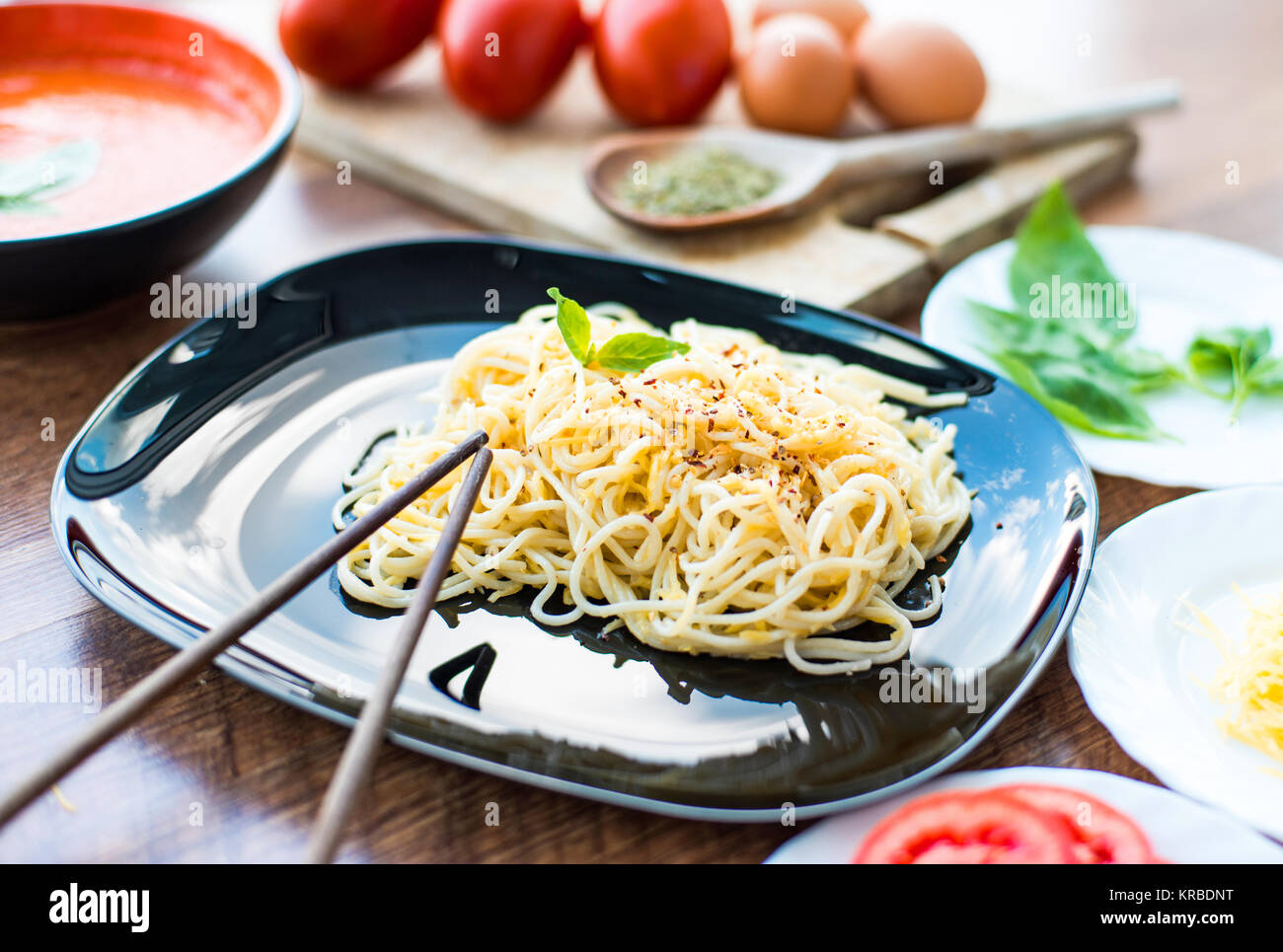 Tasty spaghetti dinner with sauce and basil Stock Photo - Alamy