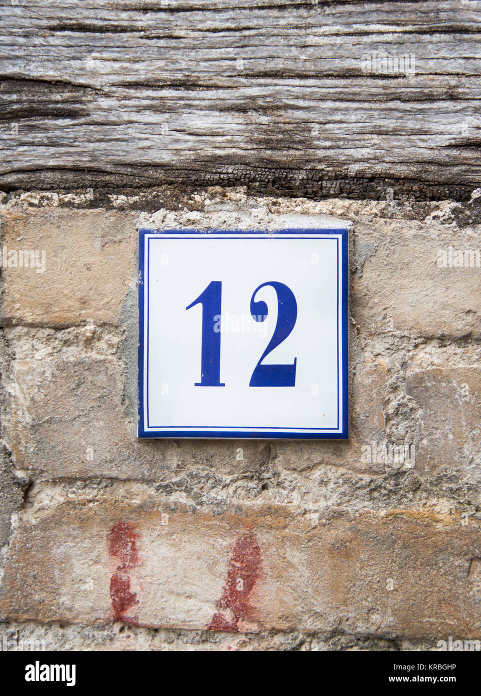 Number twelve on the grey stone wall Stock Photo - Alamy