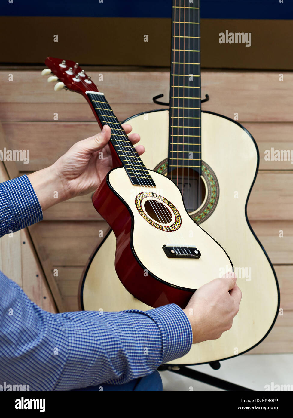 Ordinary guitar and ukulele in the store Stock Photo - Alamy