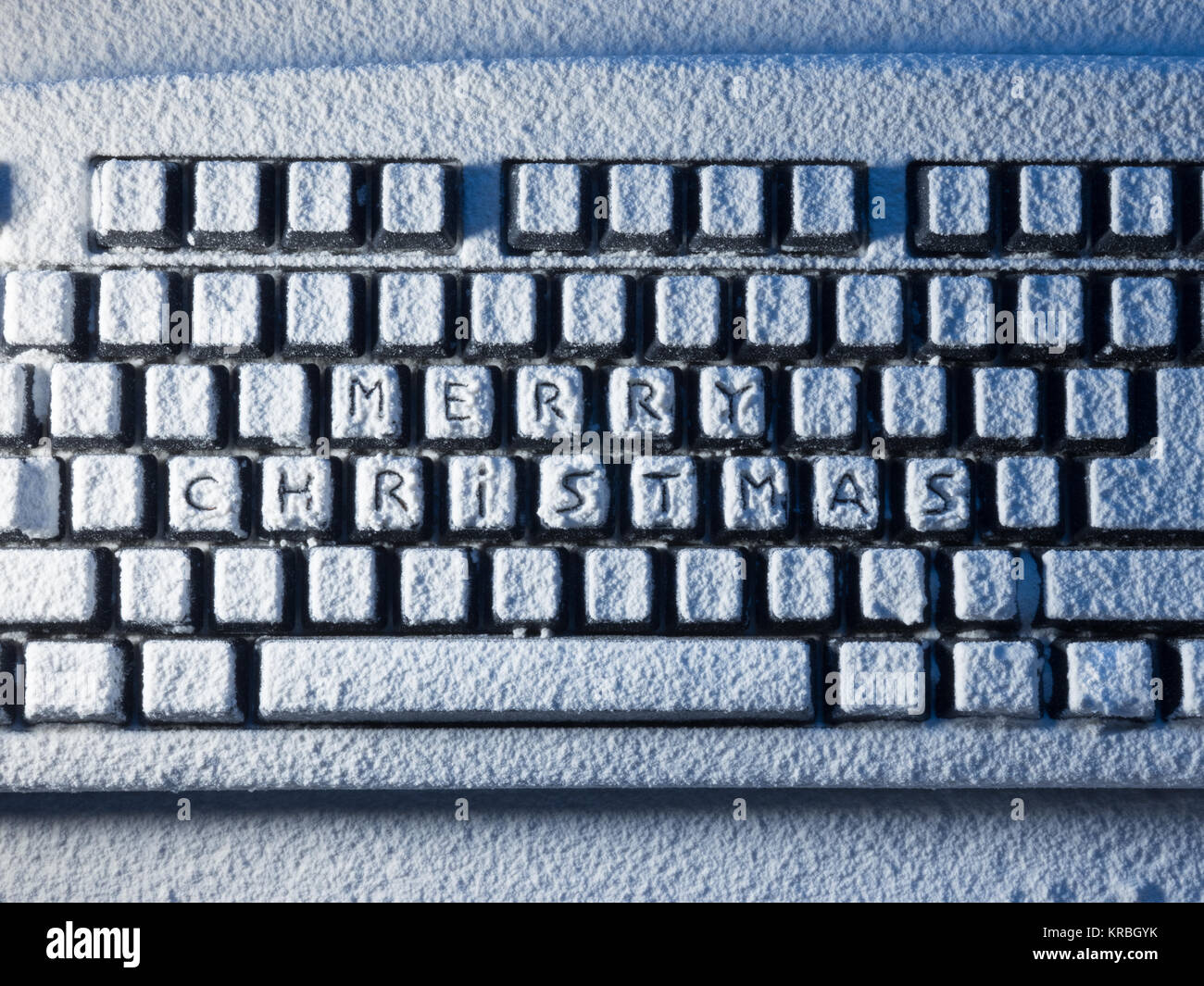 computer keyboard with text merry christmas on buttons covered with ...