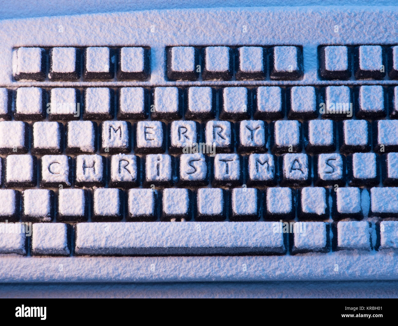 computer keyboard with text merry christmas on buttons covered with ...