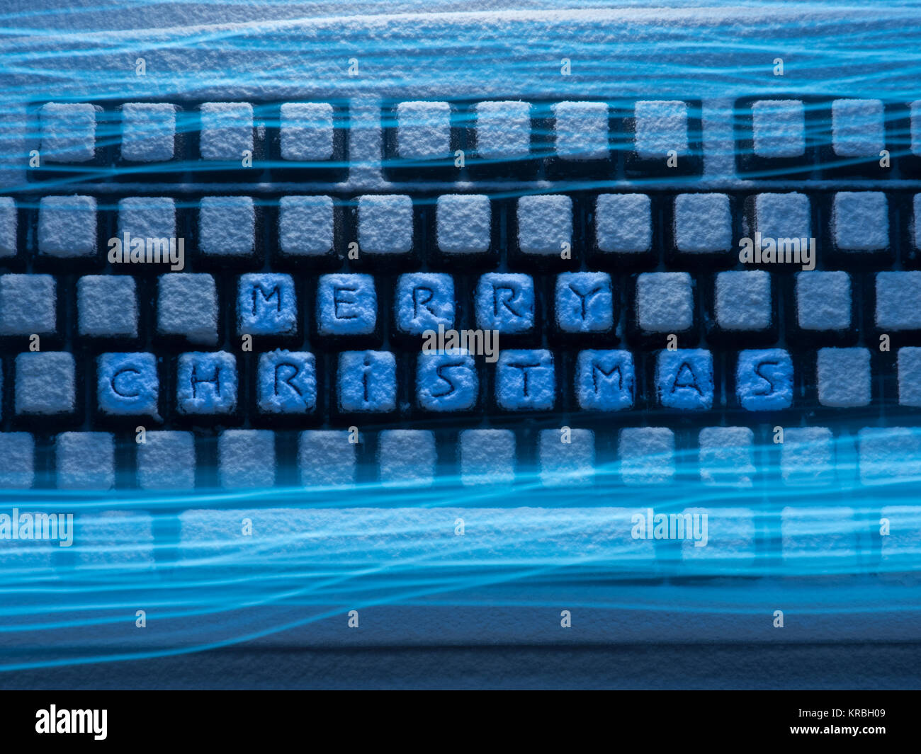 keyboard with text merry christmas on buttons covered with snow ...