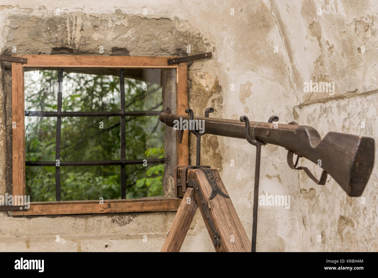 Rifle shooting from window protecting castle Stock Photo - Alamy