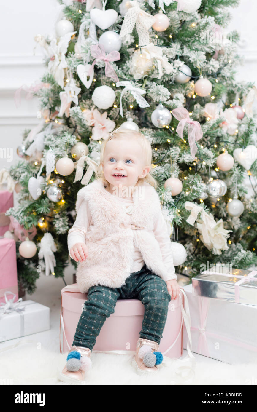 portrait beautiful little girl Christmas tree in the background. light ...