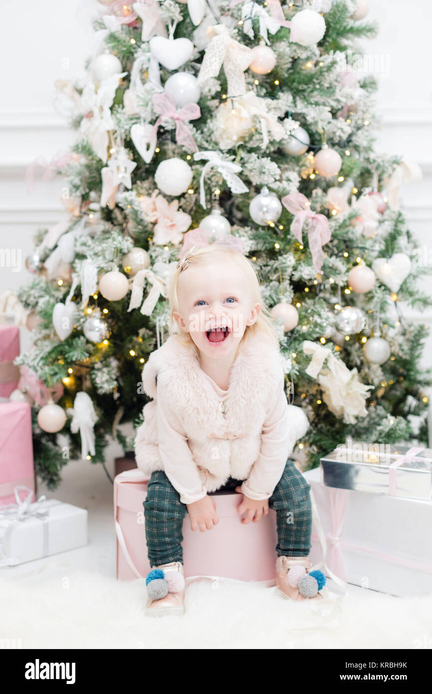 portrait beautiful little girl Christmas tree in the background. light ...
