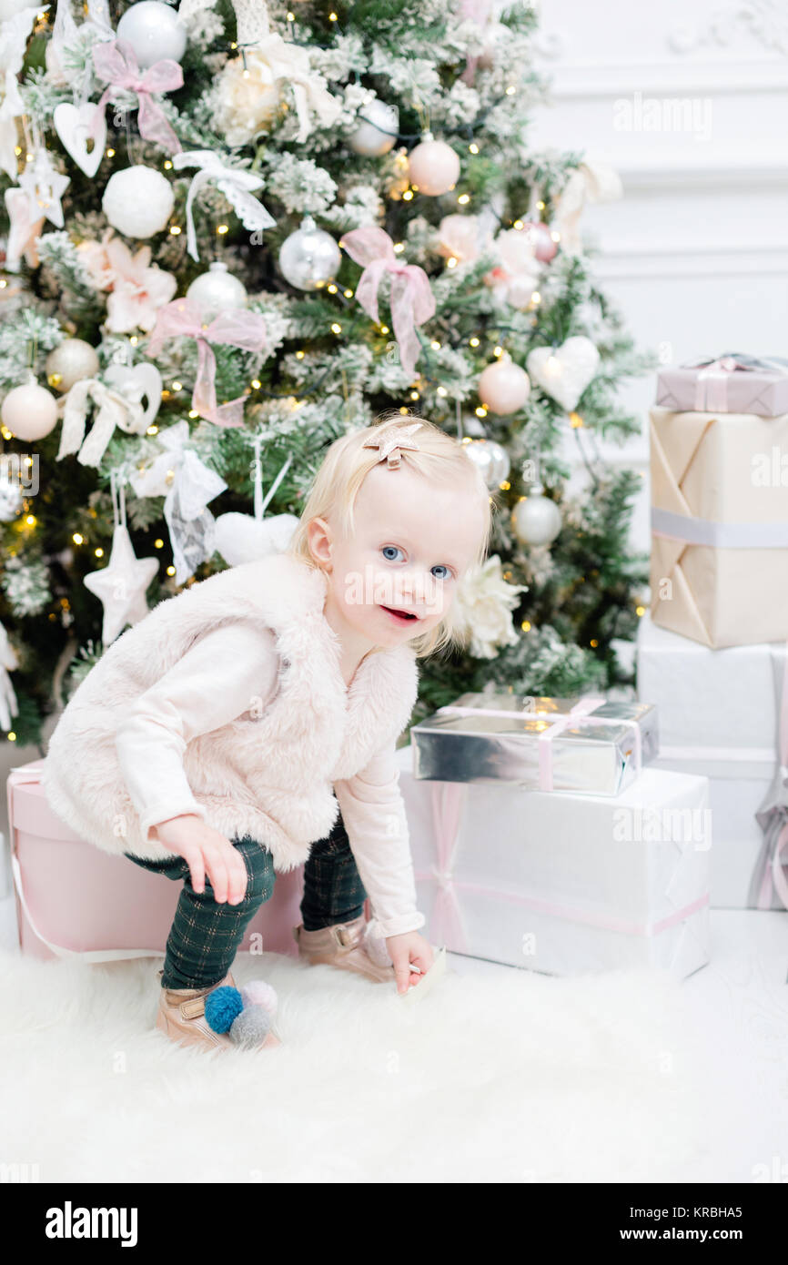 portrait beautiful little girl Christmas tree in the background. light ...