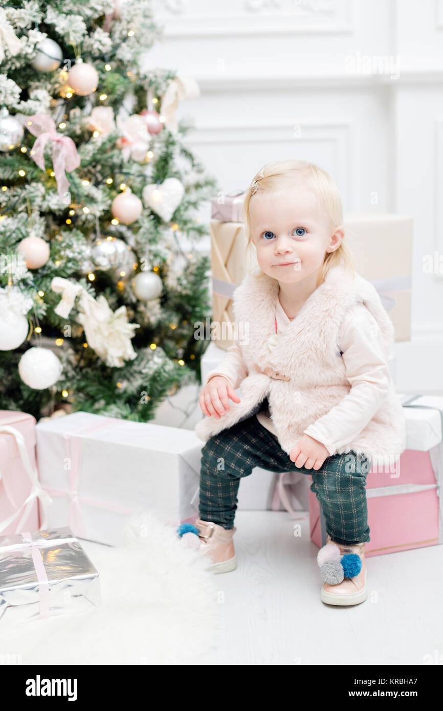portrait beautiful little girl Christmas tree in the background. light ...