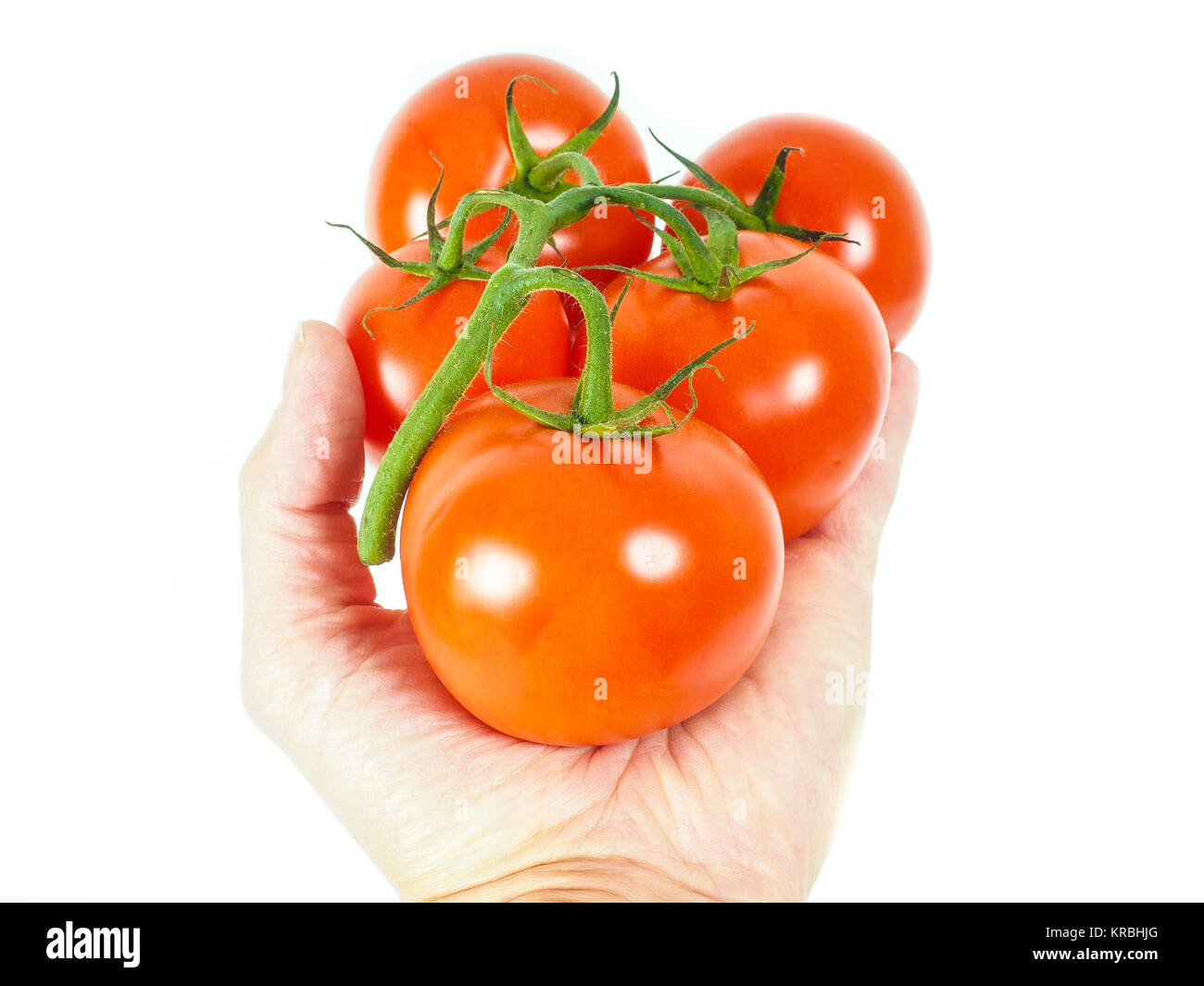 Person holding a bunch of tomatoes Stock Photo - Alamy