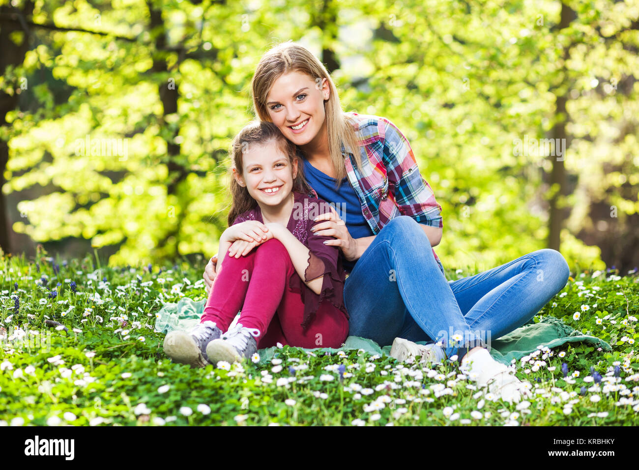 Two sisters having fun in park Stock Photo - Alamy