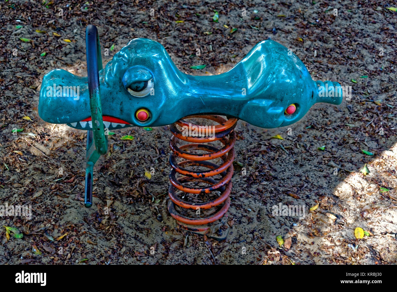 alligator spring playground ride with a rusty orange spring Stock Photo ...