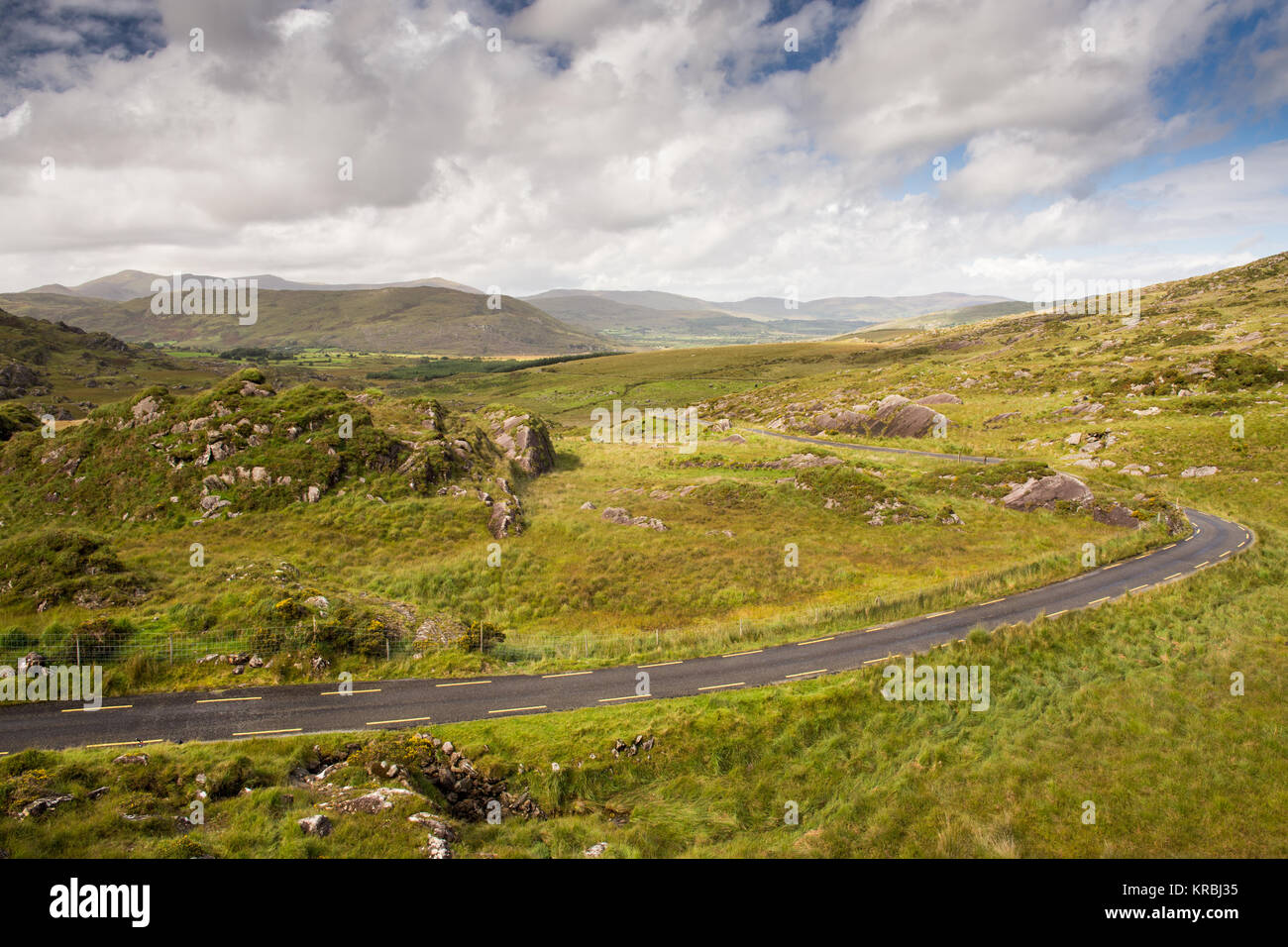 A narrow mountain pass road winds across moorland to the Ballaghbeama ...