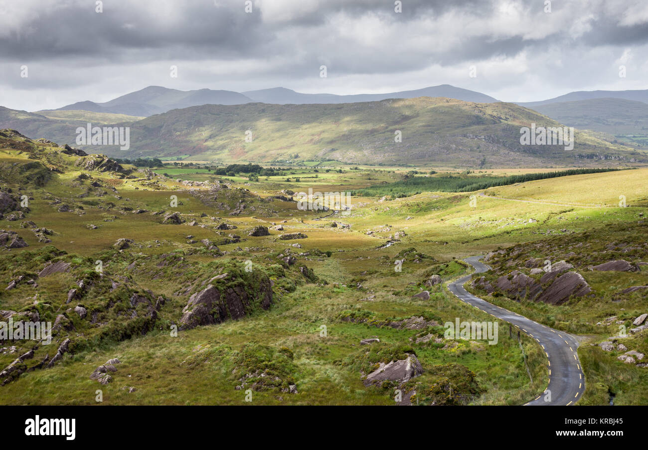A narrow mountain pass road winds across moorland to the Ballaghbeama ...
