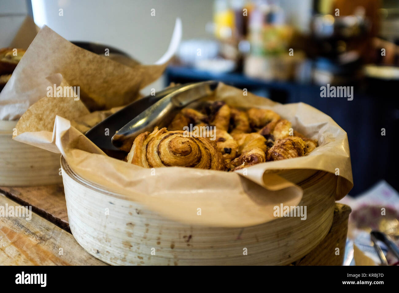 A basket of french pastry on a table serving a buffet breakfast at a ...